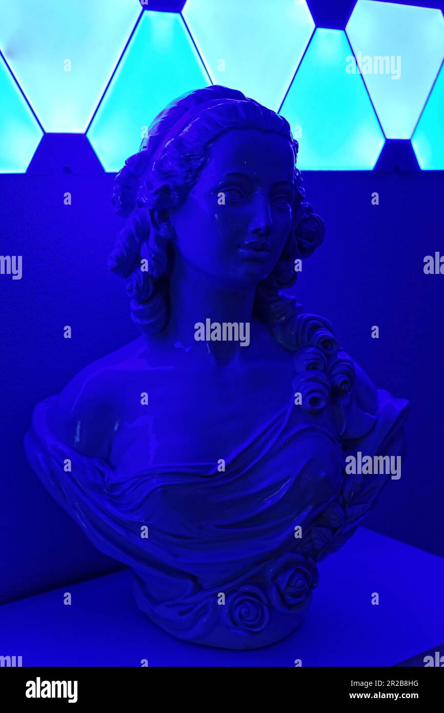 A captivating sculpture illuminated by vibrant neon lights, creating a ...