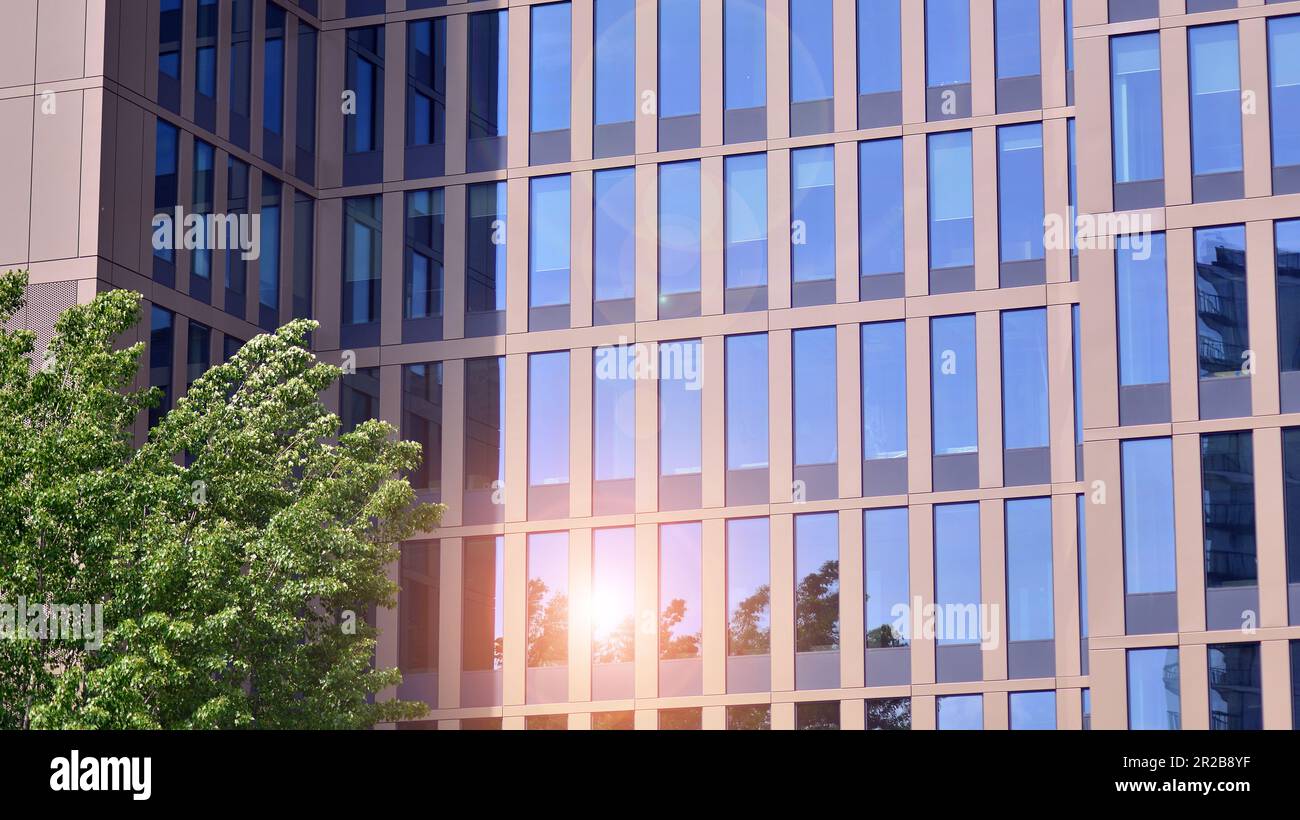 Reflection of modern commercial building on glass with sunlight. Eco ...