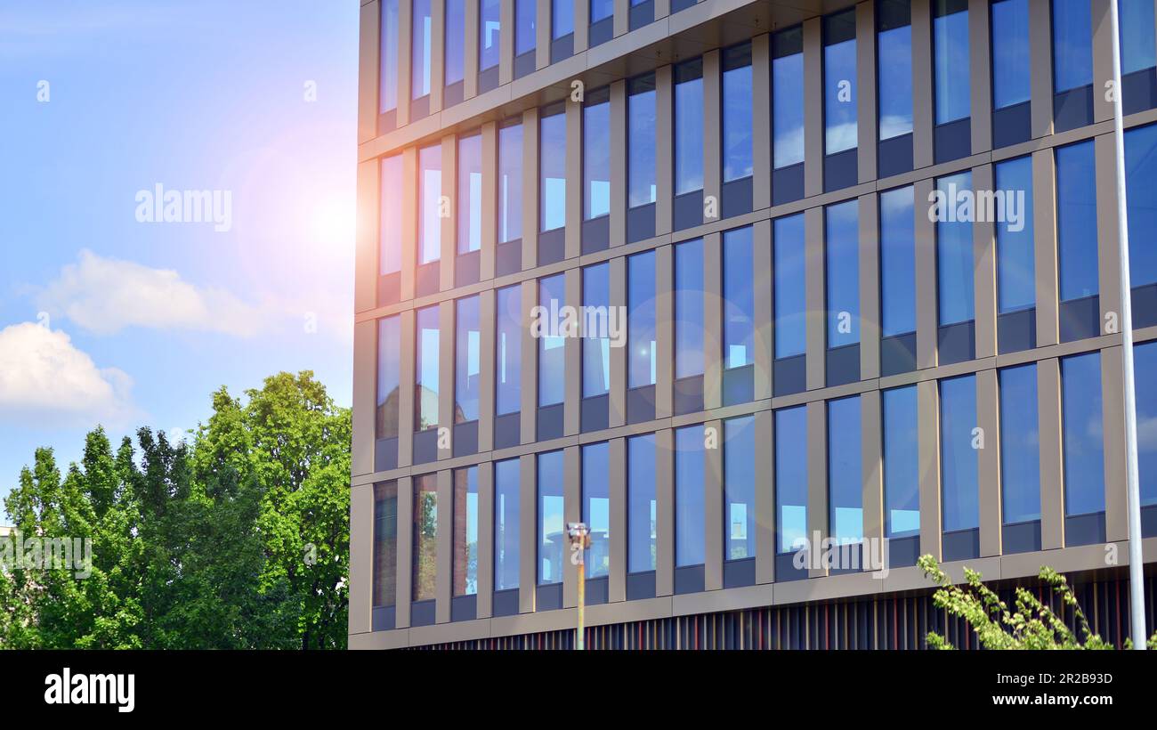Reflection of modern commercial building on glass with sunlight. Eco ...