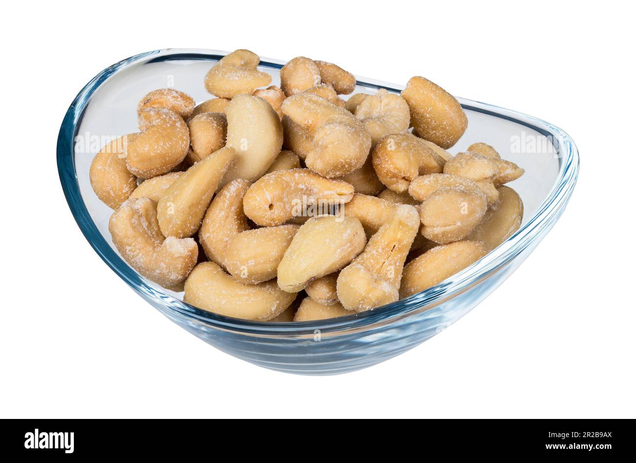 Roasted salted cashew nuts in glass bowl isolated on white background ...