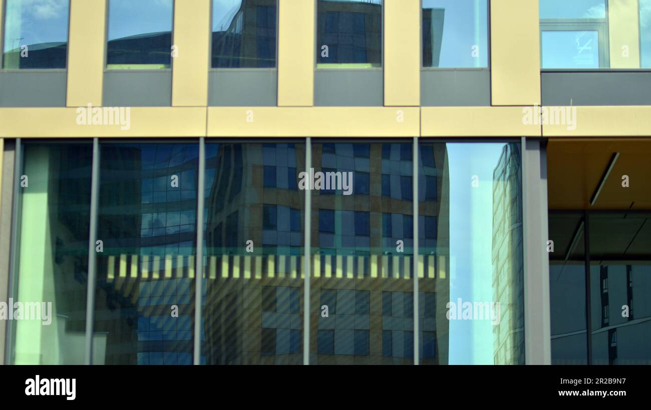 Abstract closeup of the glass-clad facade of a modern building covered ...