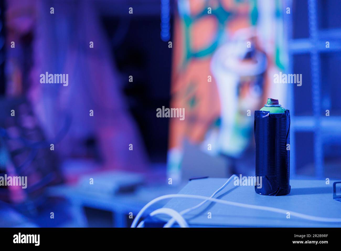 Aerosols paint cans in abandoned glowing space Stock Photo - Alamy