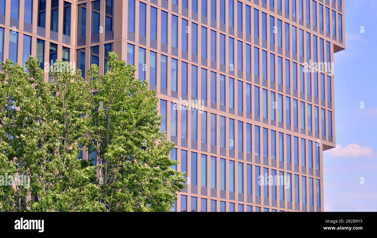 Reflection of modern commercial building on glass with sunlight. Eco ...