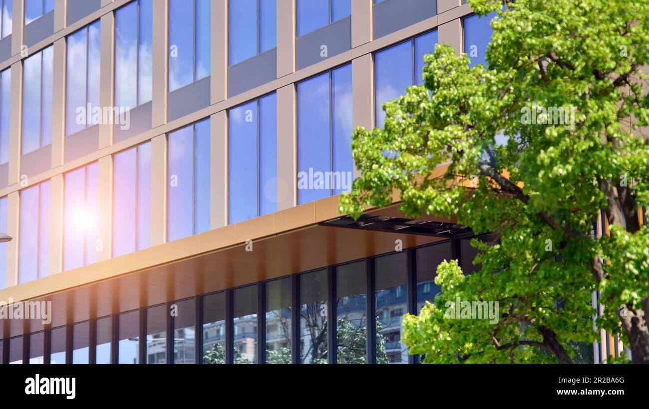 Reflection of modern commercial building on glass with sunlight. Eco ...