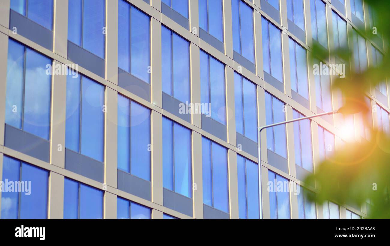 Reflection of modern commercial building on glass with sunlight. Eco ...