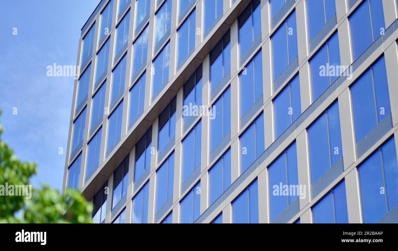 Reflection of modern commercial building on glass with sunlight. Eco ...