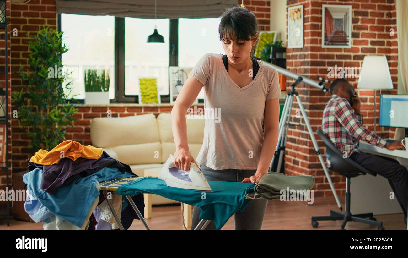 Aggressive adult ironing blouse and getting angry at husband Stock ...