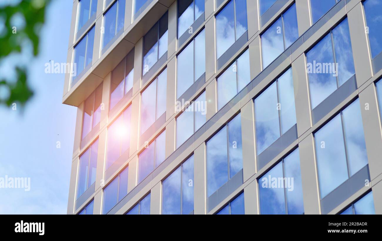 Reflection of modern commercial building on glass with sunlight. Eco ...