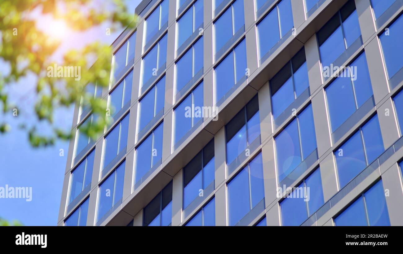 Reflection of modern commercial building on glass with sunlight. Eco ...