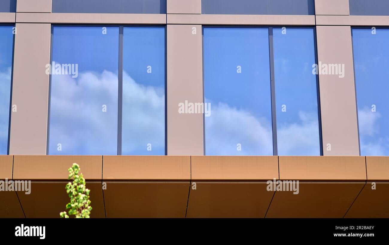 Abstract closeup of the glass-clad facade of a modern building covered ...