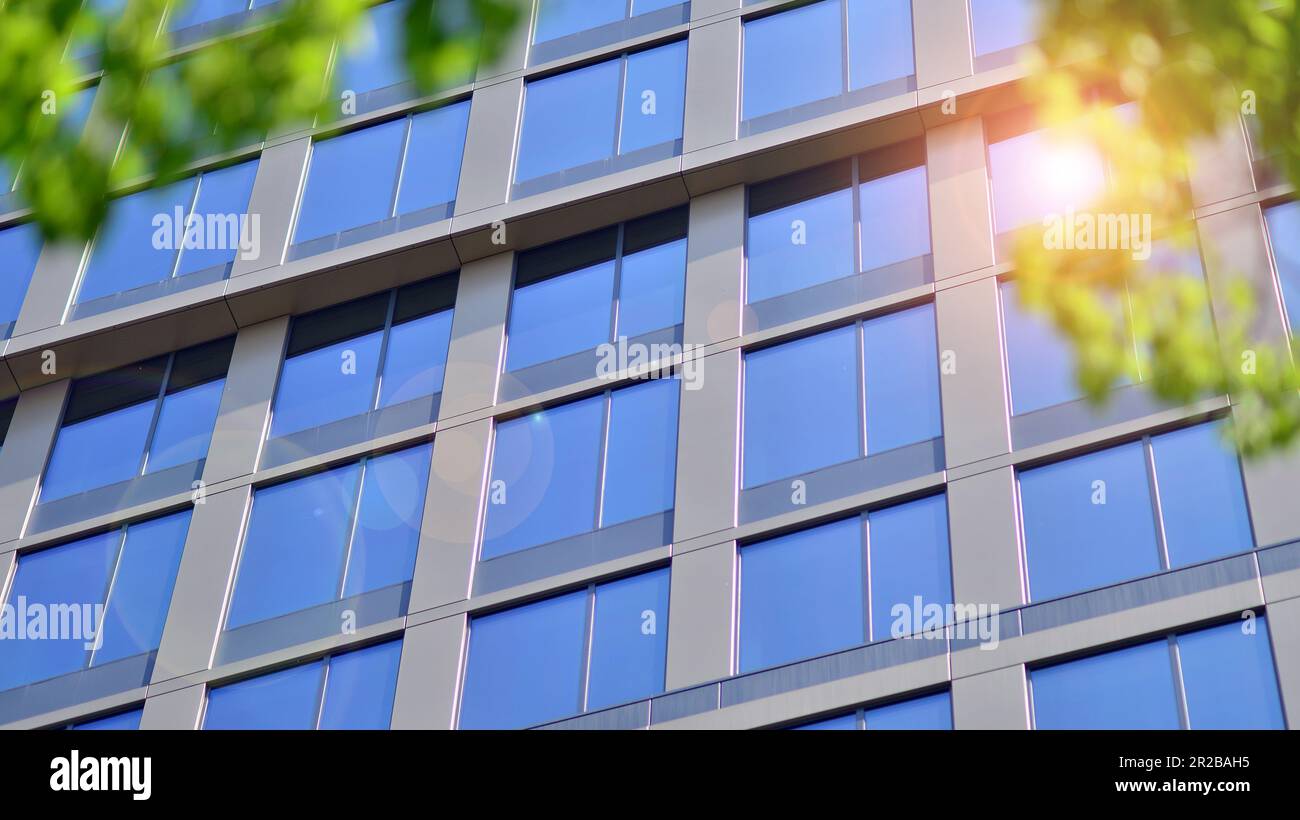 Reflection of modern commercial building on glass with sunlight. Eco ...