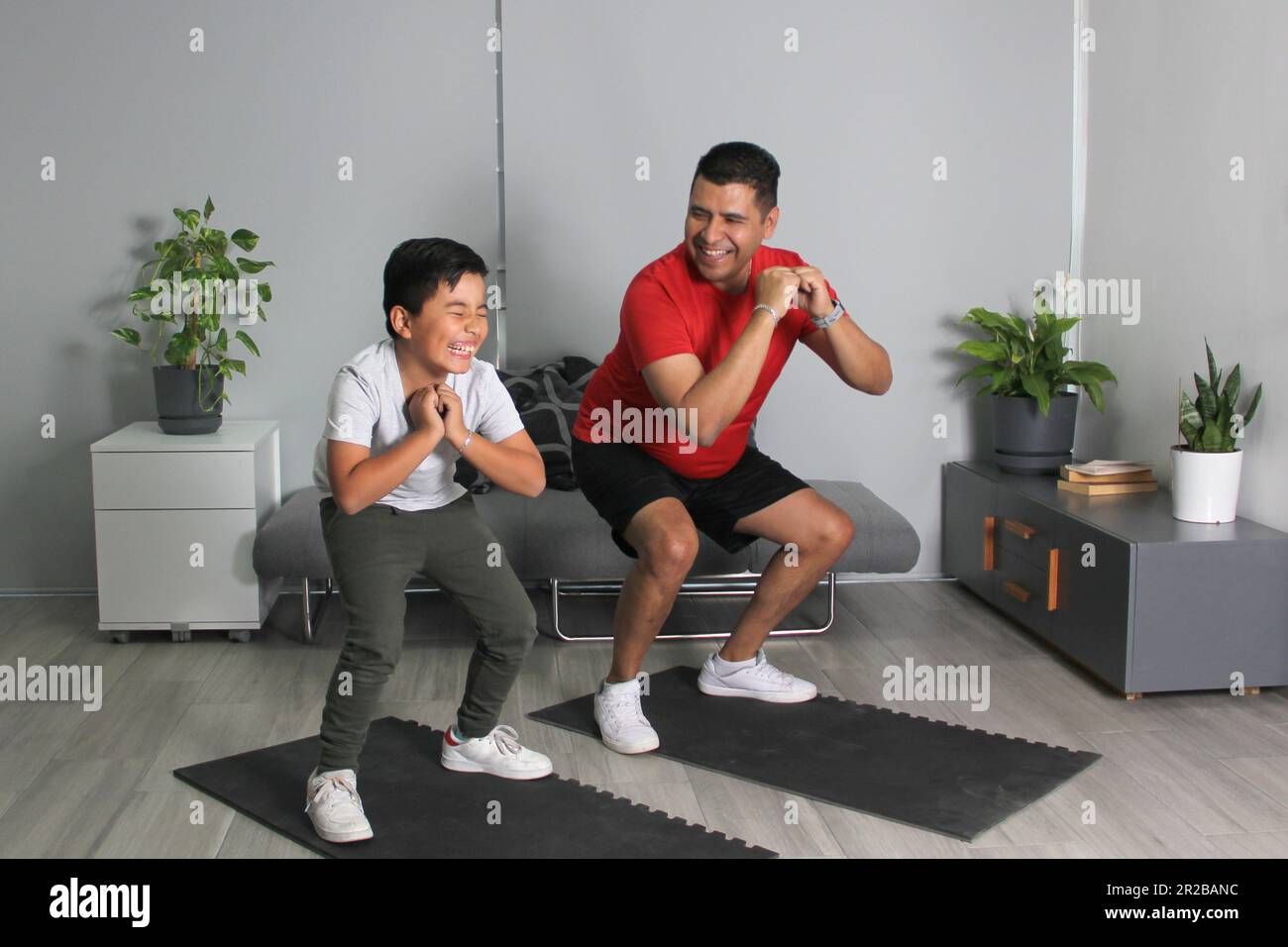 Boxing classes in the living room of his house between dad and son as a ...