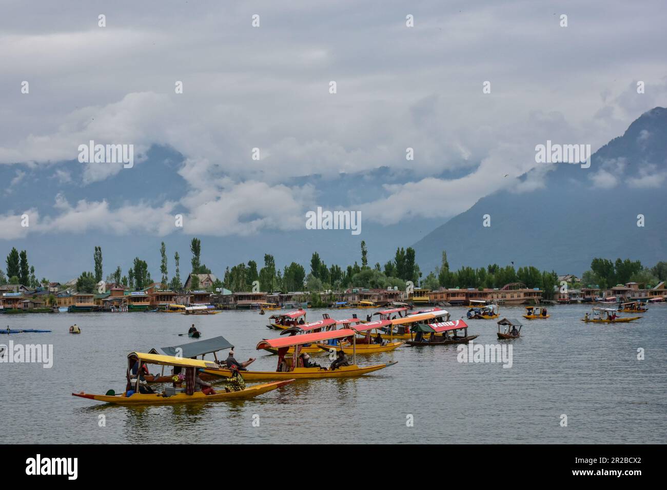 Indian tourists enjoy boat ride across the world famous Dal lake during a cloudy weather in ...