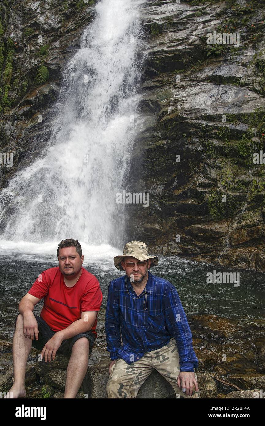 PNG Papua New Guinea Eastern Highlands Goroka; tourists at a waterfall ...