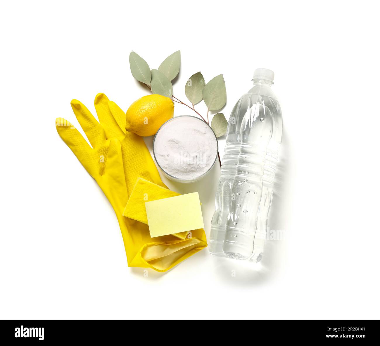 Bottle of vinegar, baking soda, cleaning sponges, lemon and rubber ...