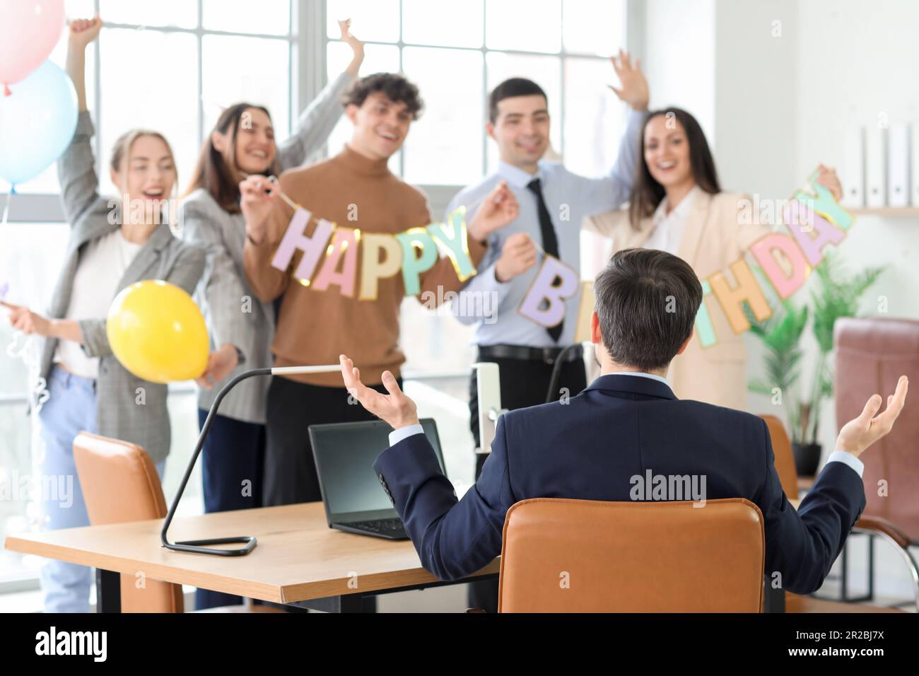 Group of business people greeting their colleague at birthday party in ...