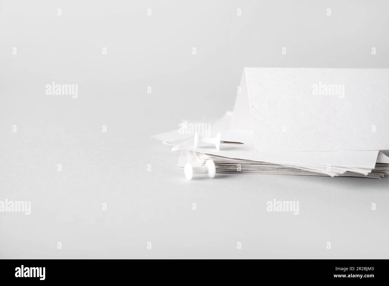White sticky notes with pins on grey background Stock Photo - Alamy