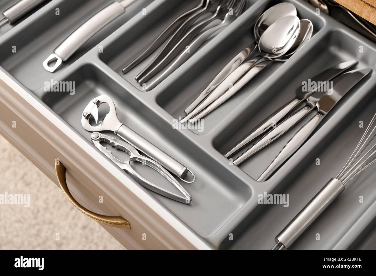 Open kitchen drawer with different silver cutlery, closeup Stock Photo ...