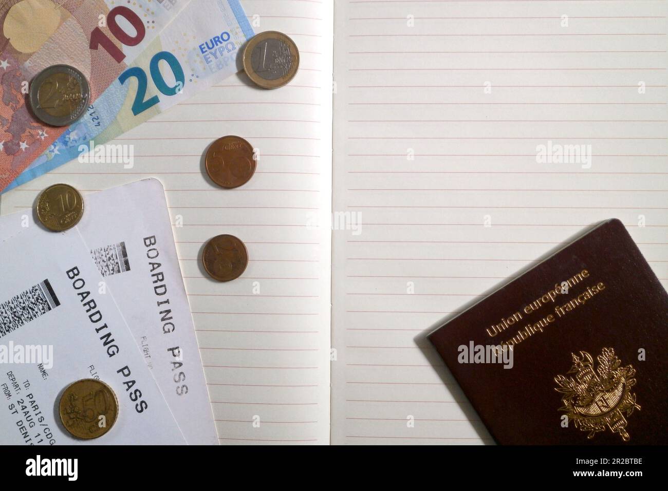 Some euro coins and banknotes as well as a french passport and 2 ...