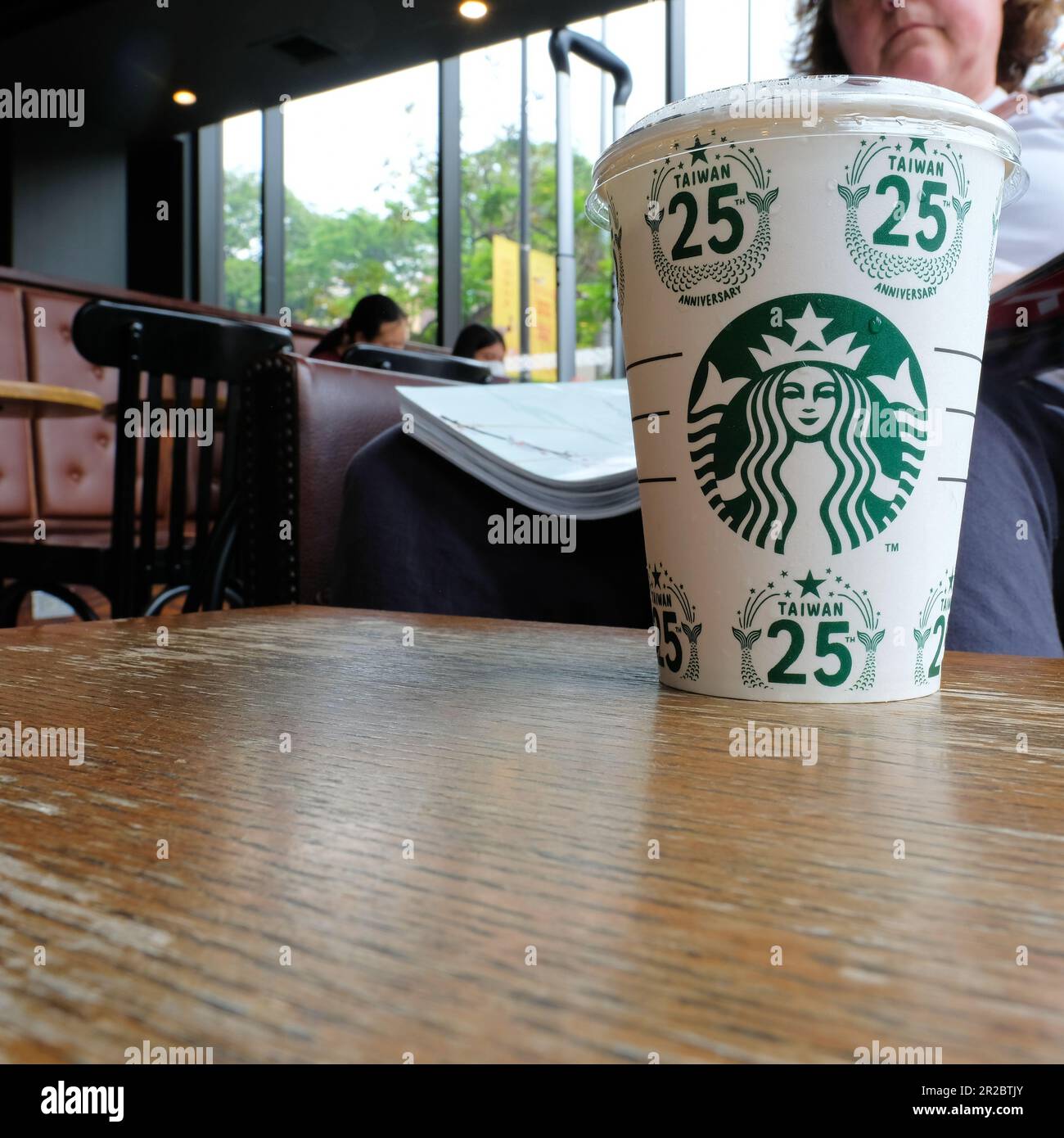 Starbuck's coffee cup commemorating the 25th anniversary of the company ...