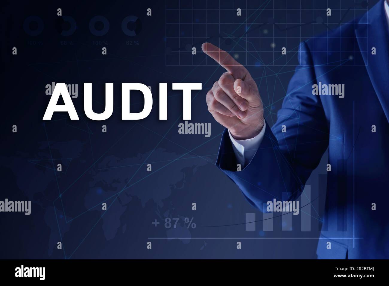 Audit concept. Businessman pointing at graph on dark blue background ...
