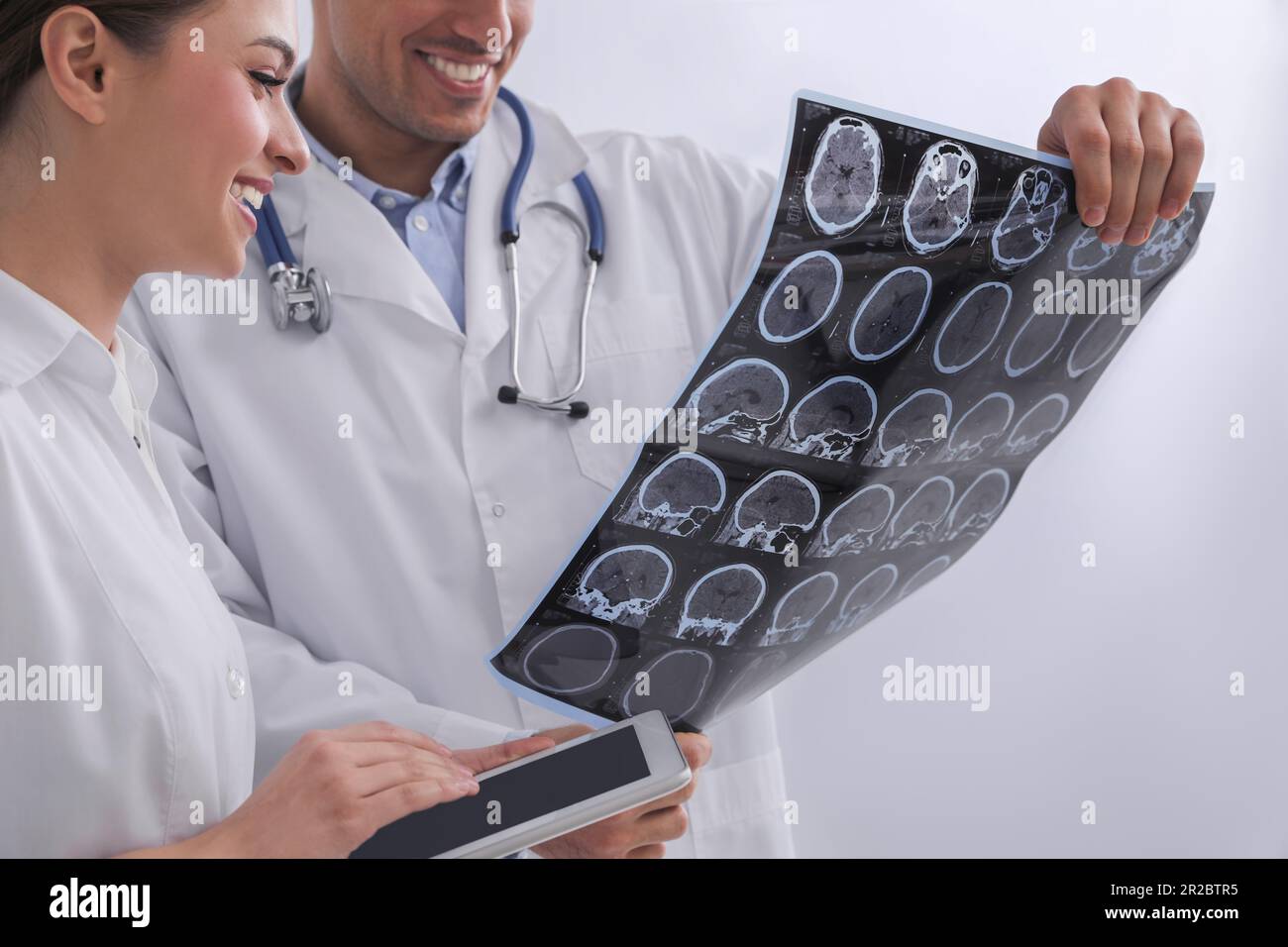 Doctors examining MRI images of patient with multiple sclerosis in ...