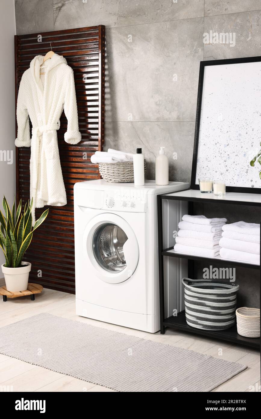 Stylish laundry room with modern washing machine. Interior design Stock ...