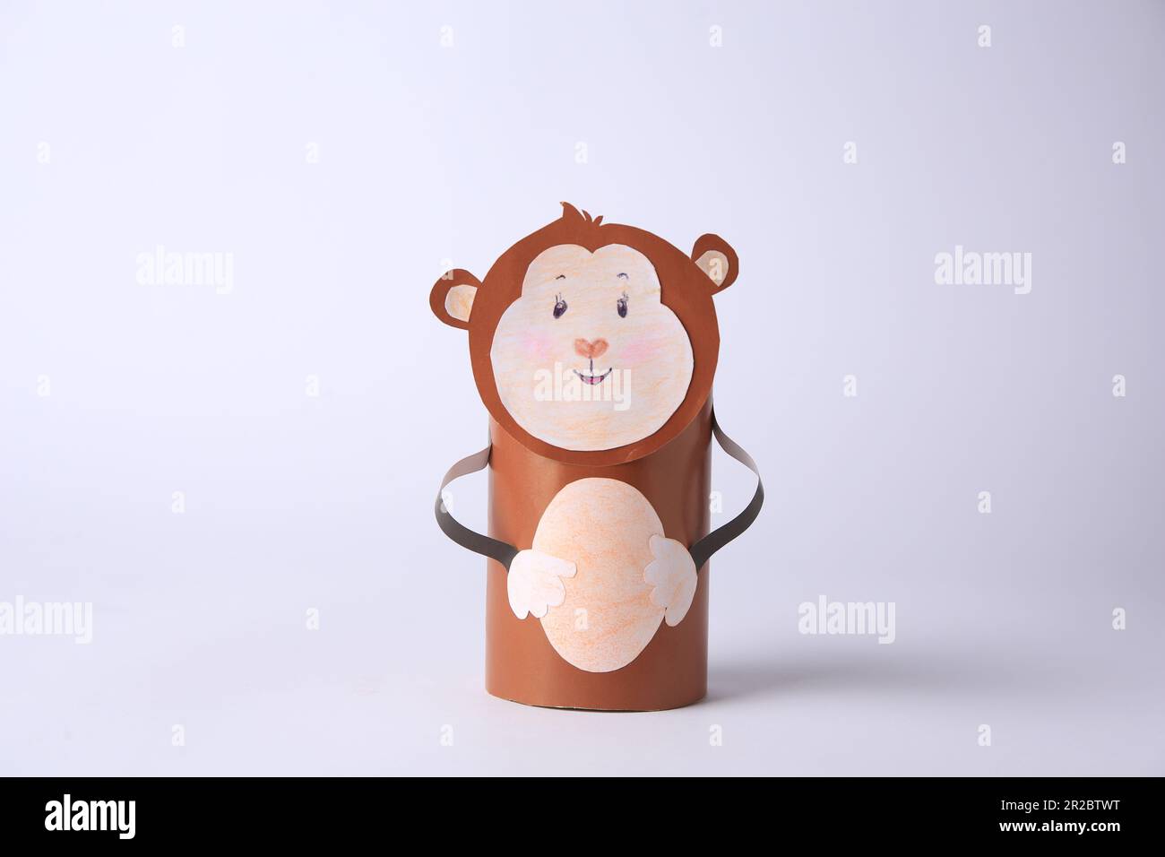 Toy monkey made from toilet paper hub on white background. Children's ...