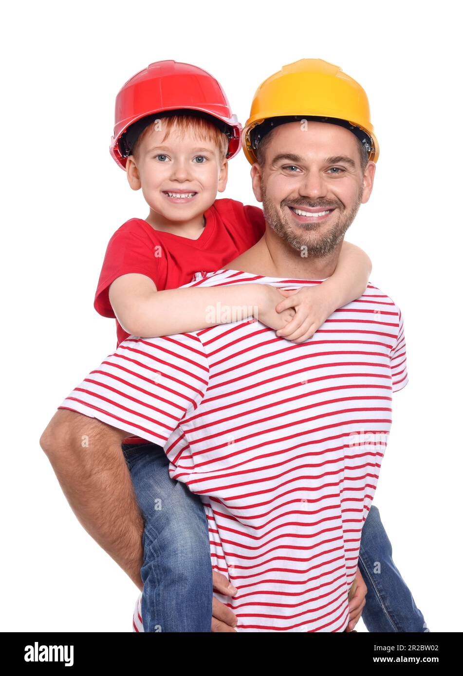 Father and son in hard hats having fun on white background Stock Photo ...