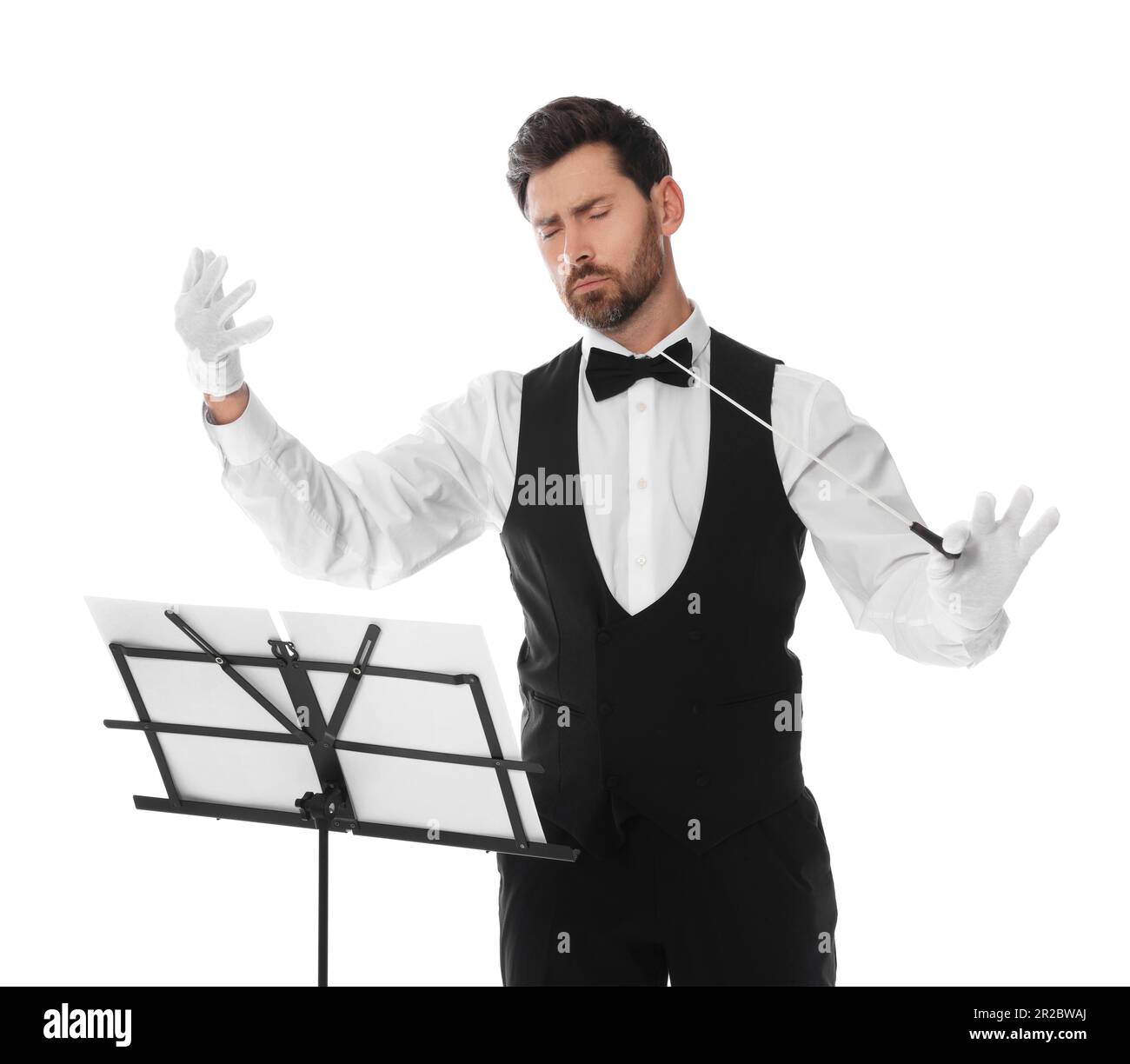 Professional conductor with baton and note stand on white background ...