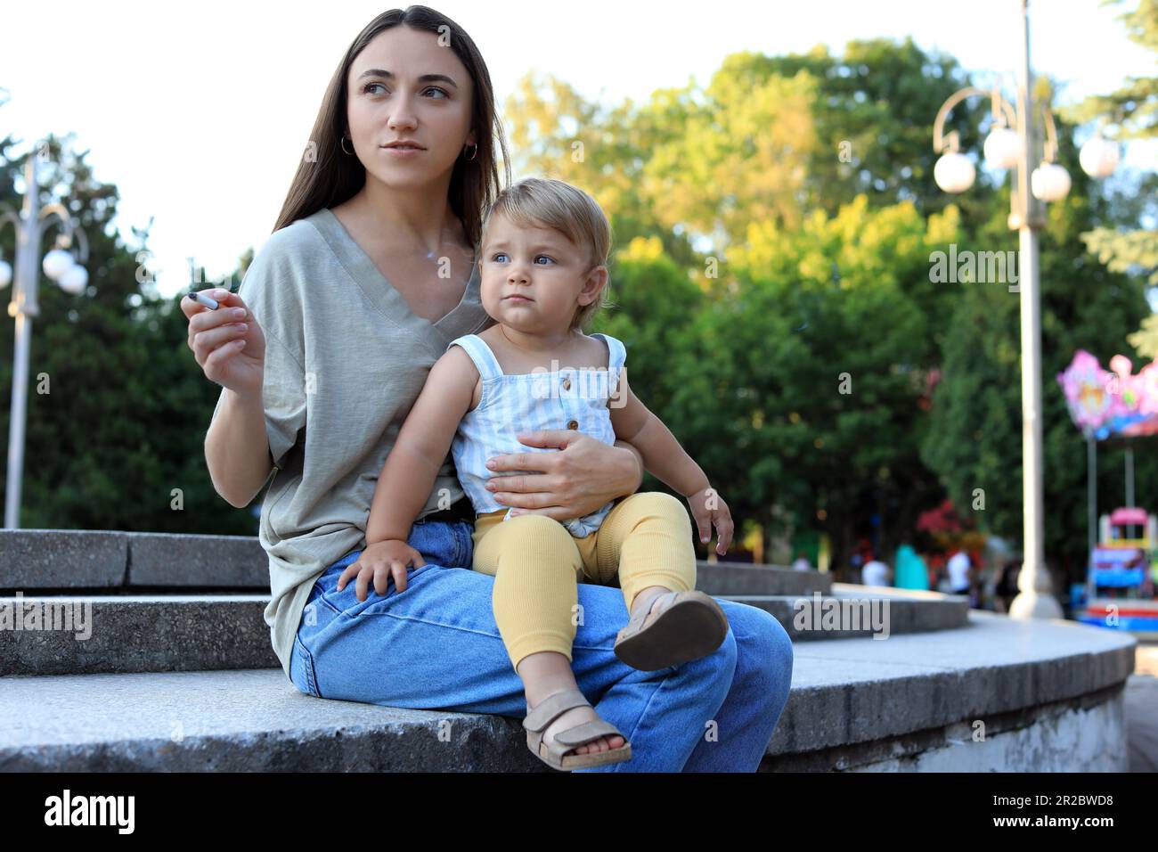 Mother with cigarette and child outdoors. Don't smoke near kids Stock ...