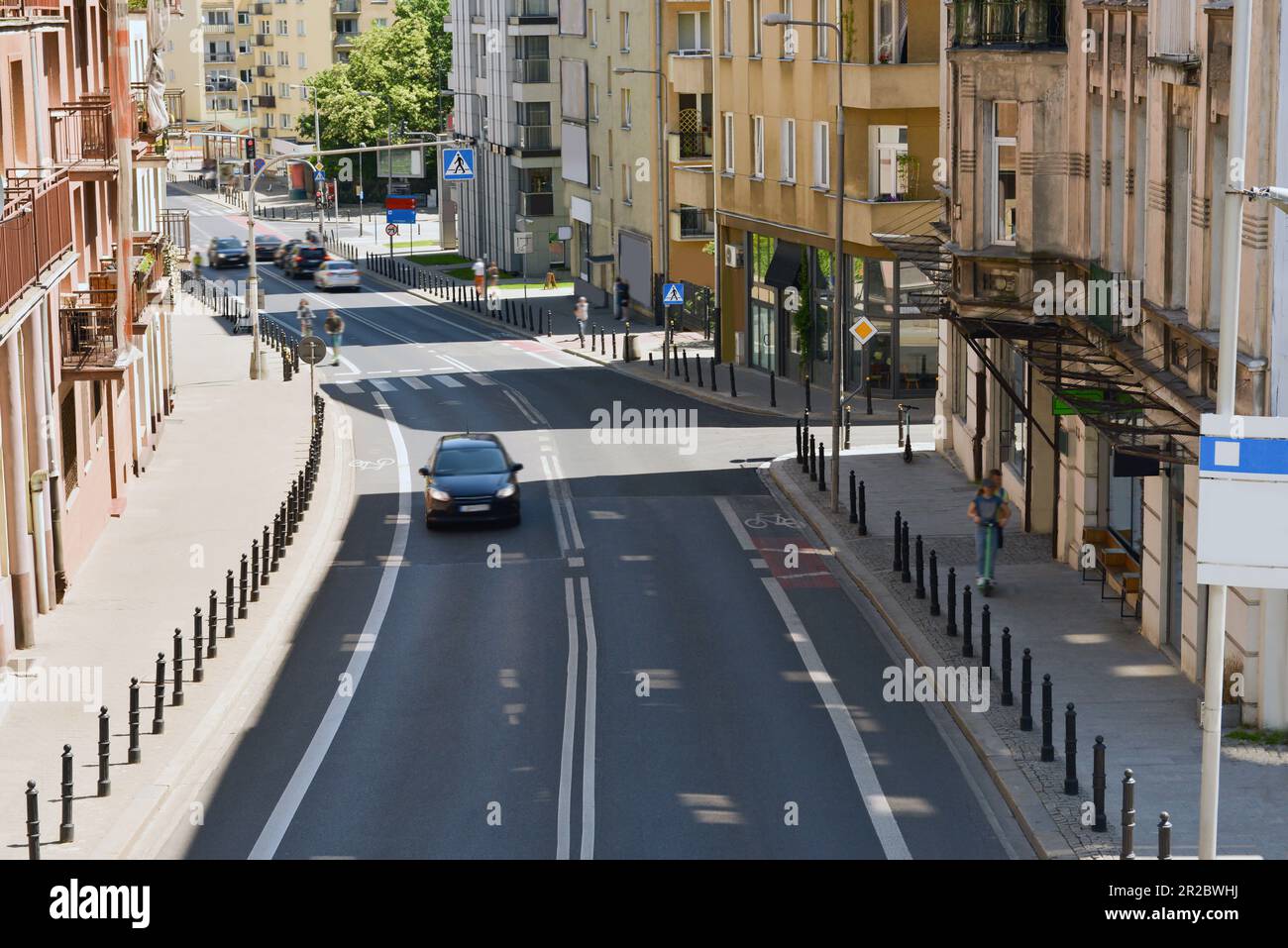Beautiful road with cars near buildings in city Stock Photo - Alamy