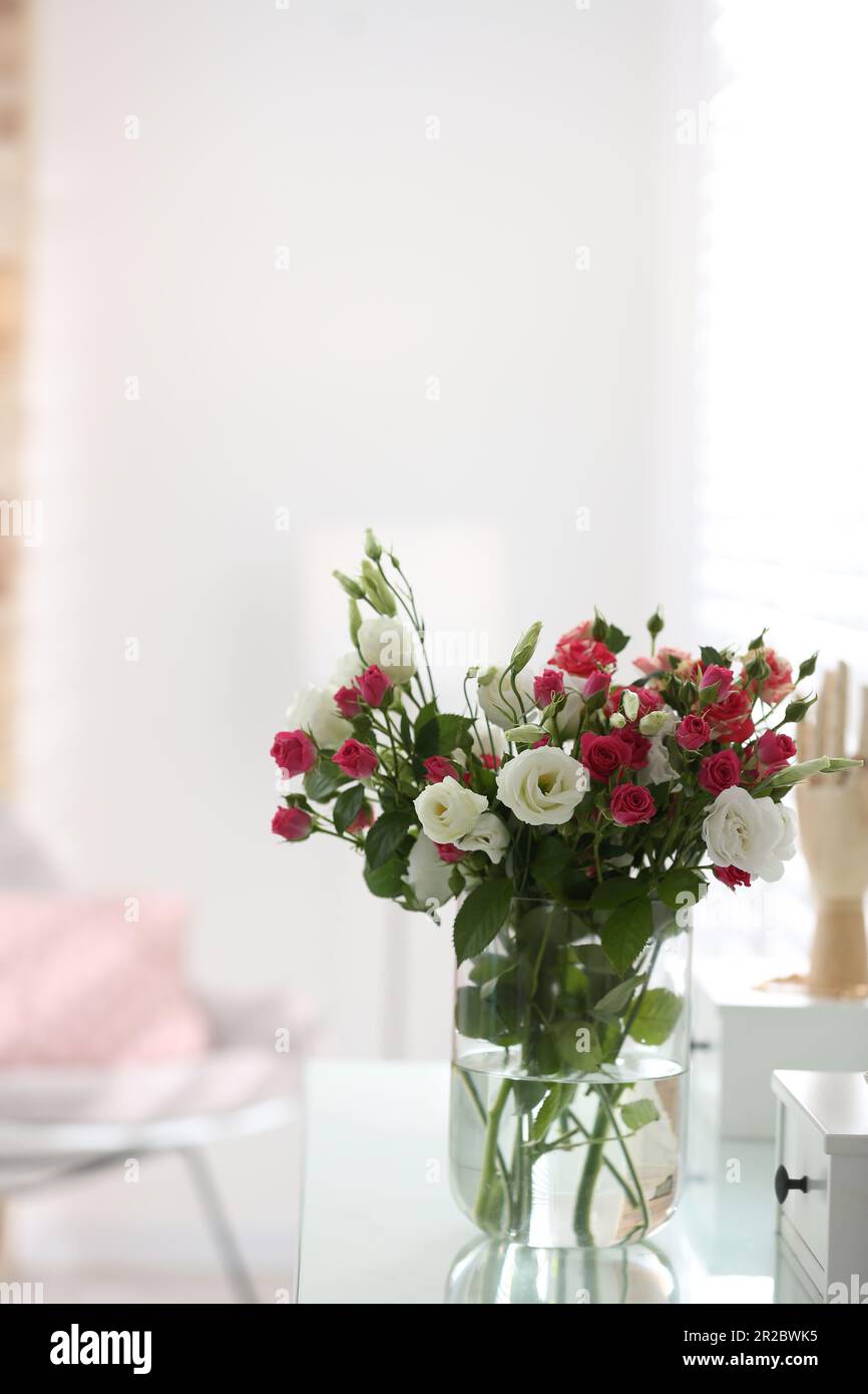 Glass vase with fresh flowers on dressing table indoors. Space for text ...