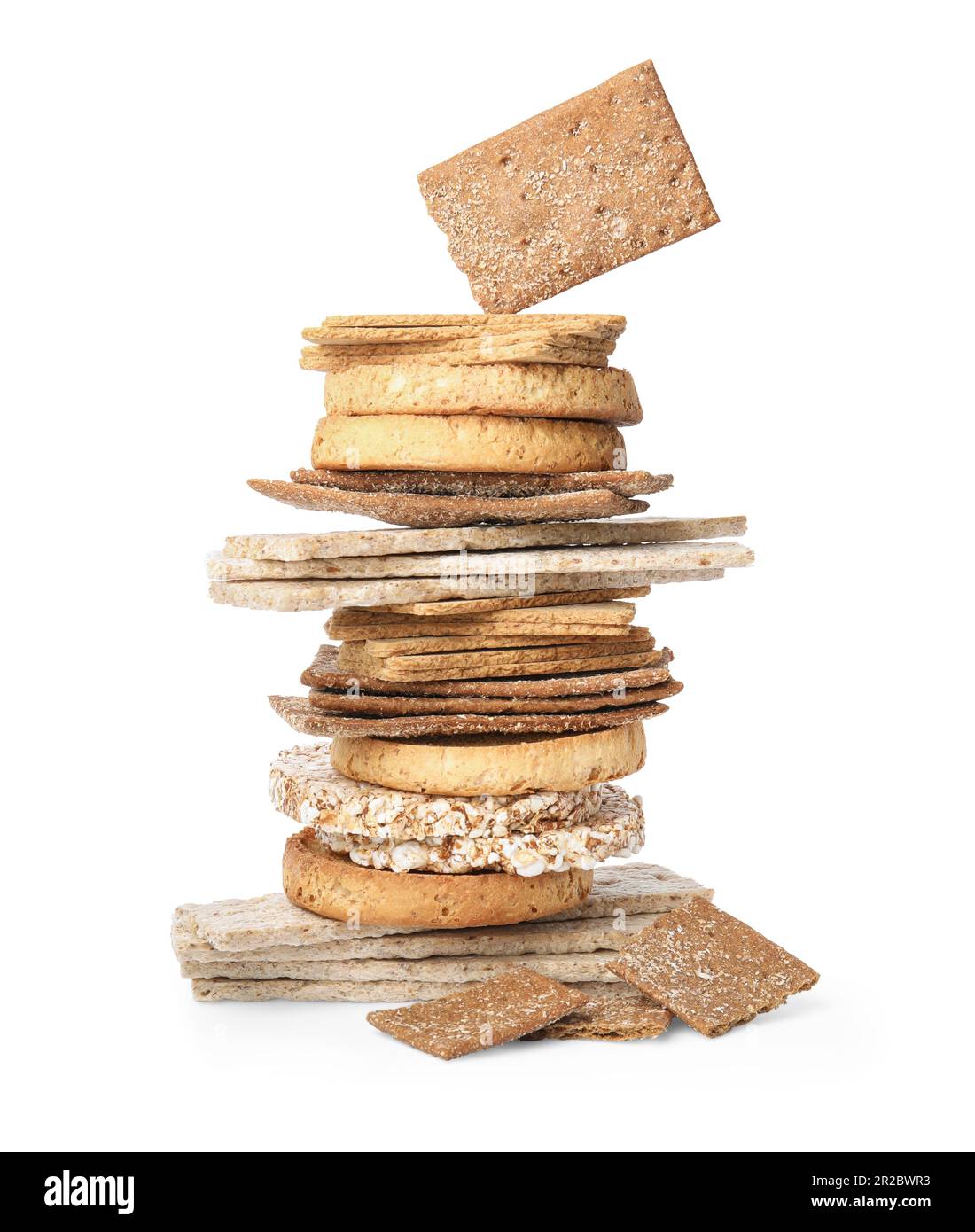 Stack of fresh rye crispbreads, crunchy rice cakes and rusks on white ...