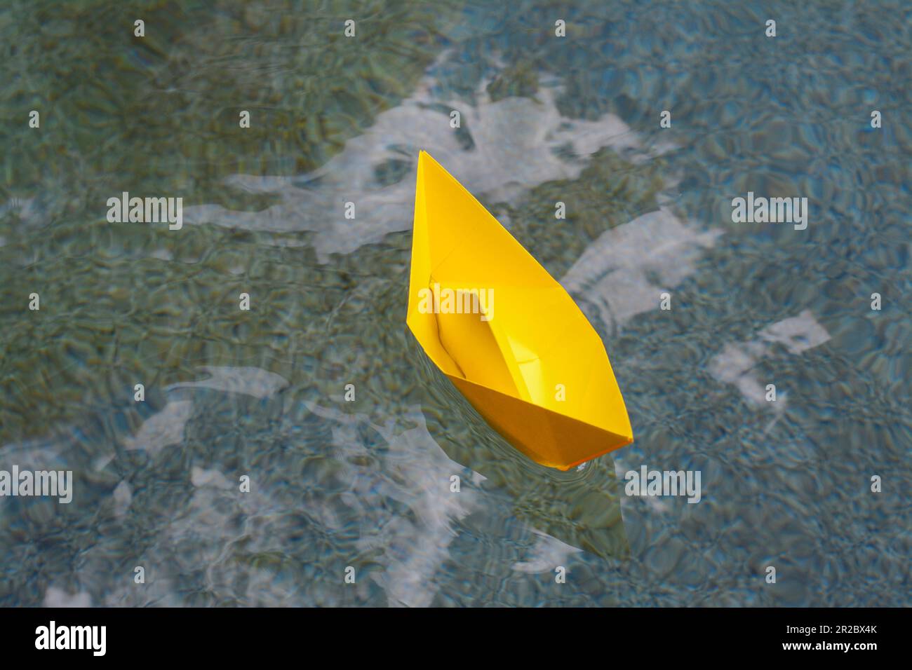 Beautiful yellow paper boat on water outdoors Stock Photo - Alamy