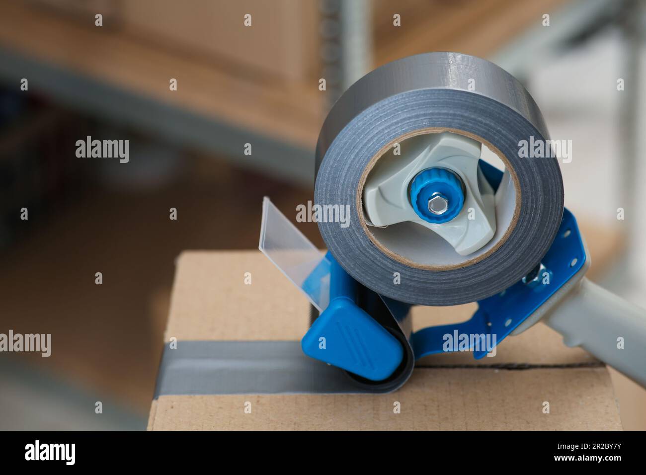 Taping box with adhesive tape dispenser indoors. Space for text Stock ...