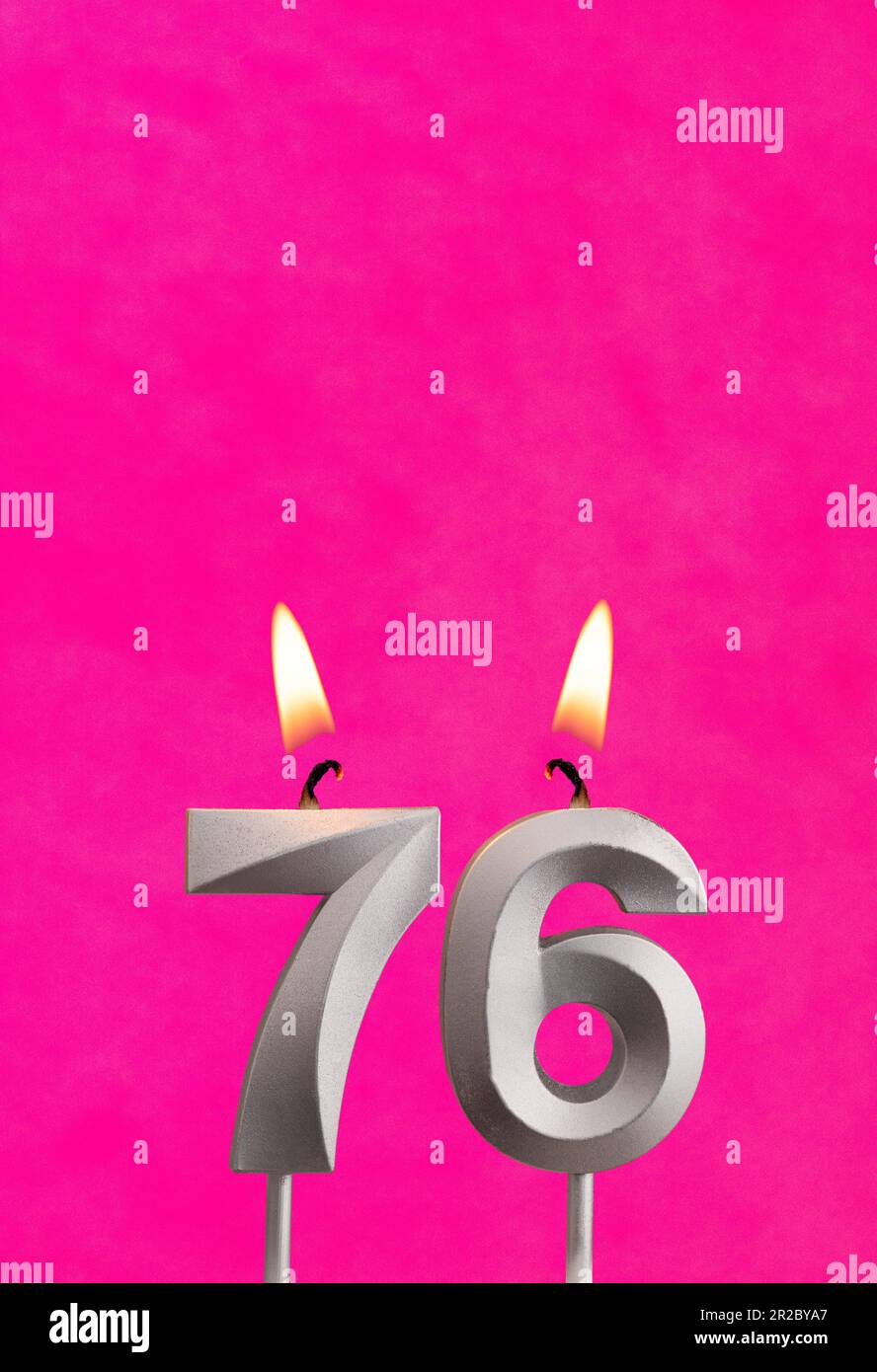 Candle 76 with flame - Silver anniversary candle on a fuchsia ...