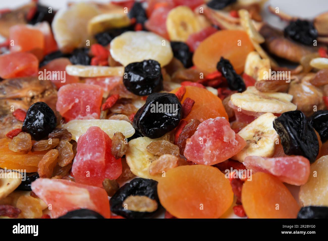 Pile of different tasty dried fruits as background, closeup Stock Photo ...
