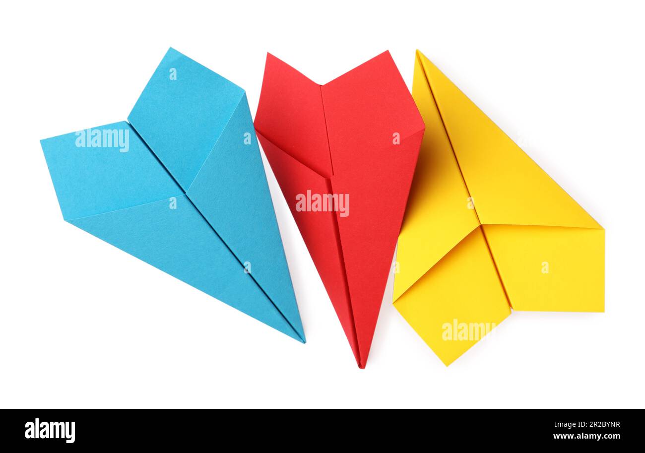 Handmade yellow, light blue and red paper planes isolated on white, top ...