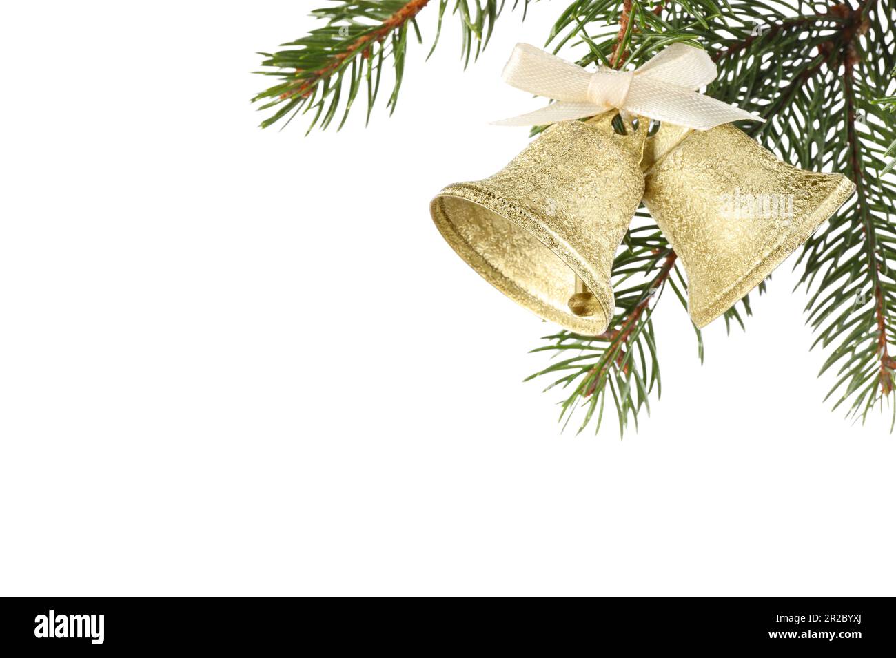 Christmas bells with bow hanging on fir tree branch against white ...