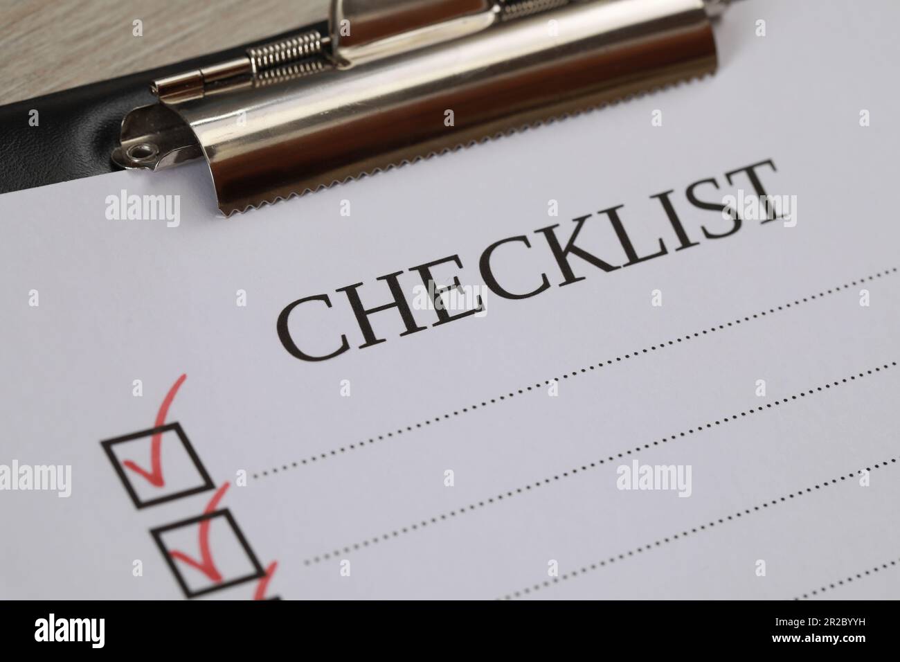 Clipboard with inscription Checklist on table, closeup Stock Photo - Alamy