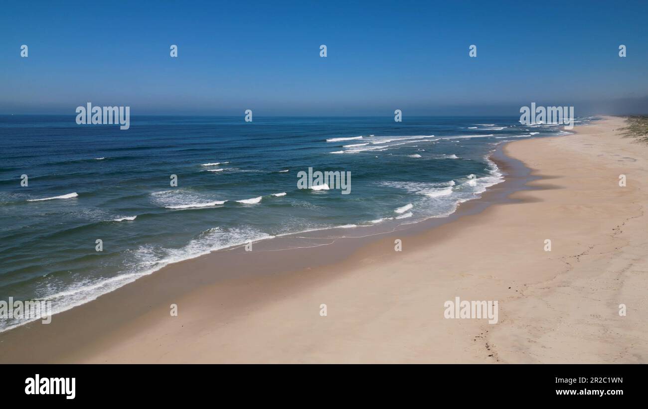 Side view of waves crashing on sandy beach aerial - a bird's eye view ...