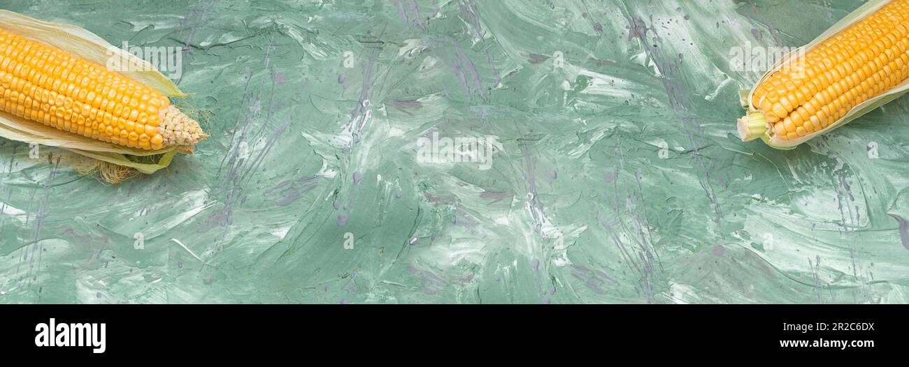 Yellow organic sweet corn on green marble malachite banner background ...