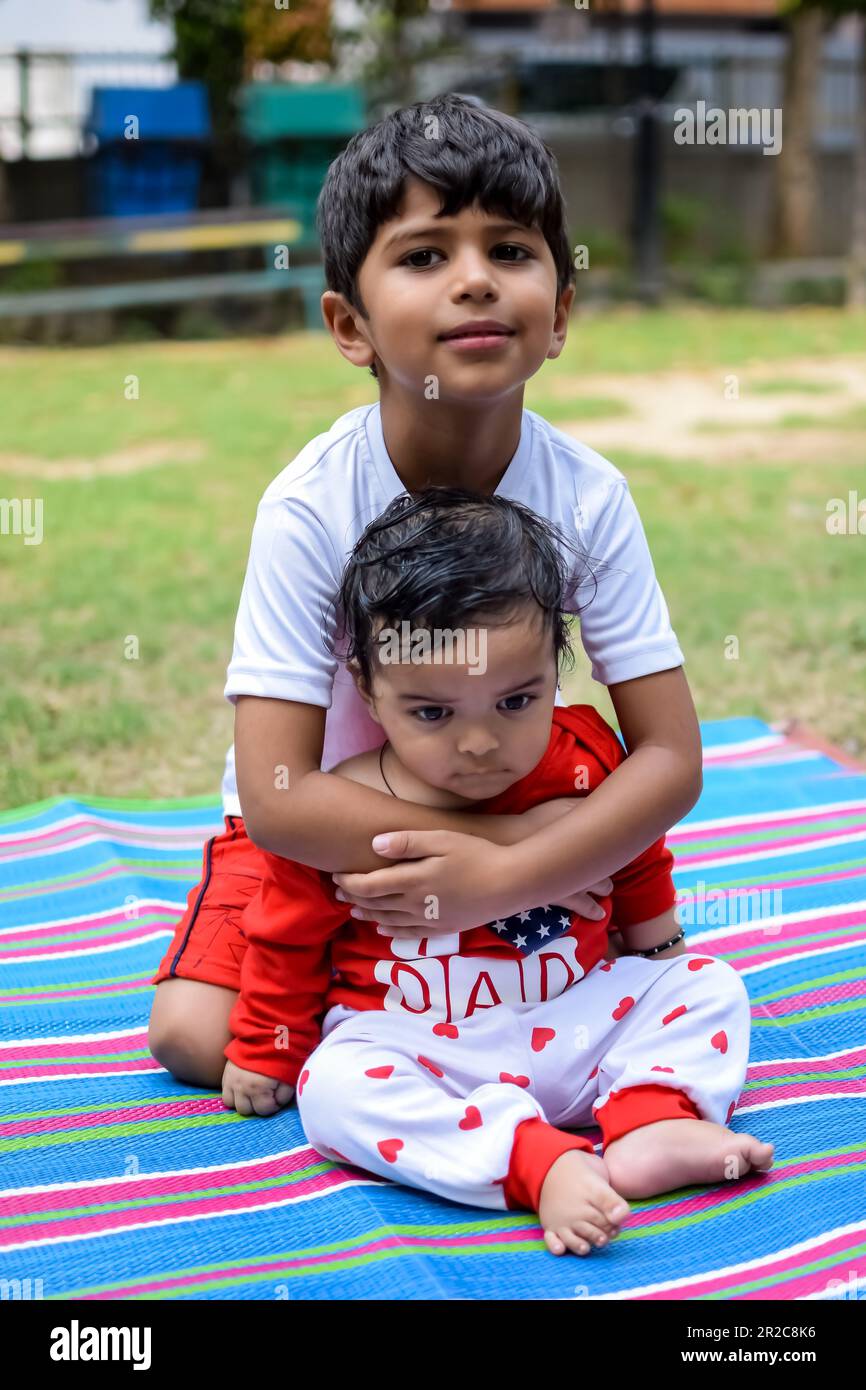Two happy boys in society park, happy Asian brothers who are smiling ...