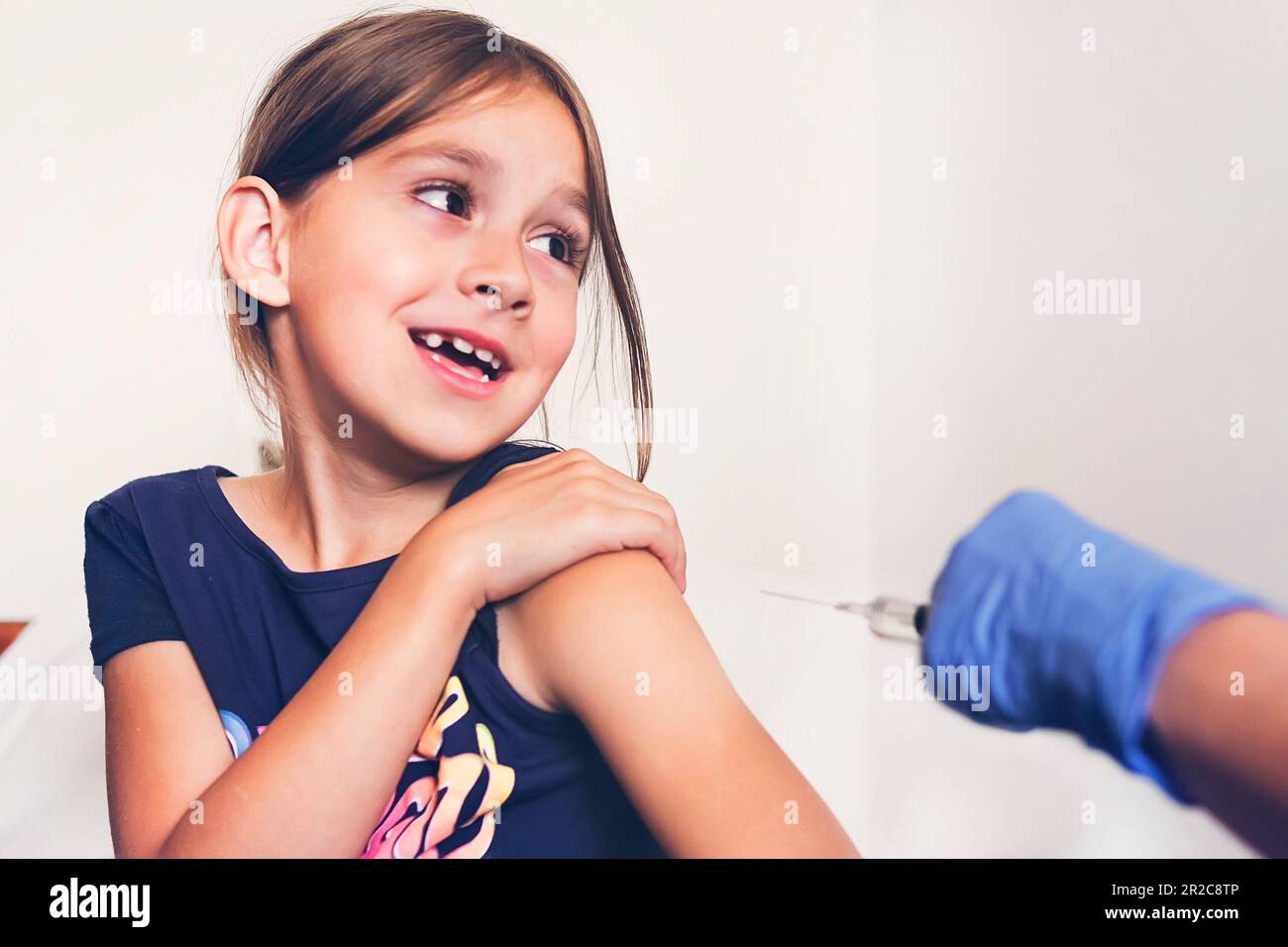 A little girl screams in fear of being shot in the shoulder ...