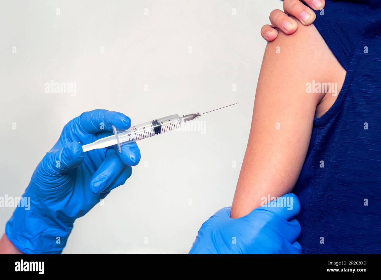 doctor makes the patient an injection on white background close up ...