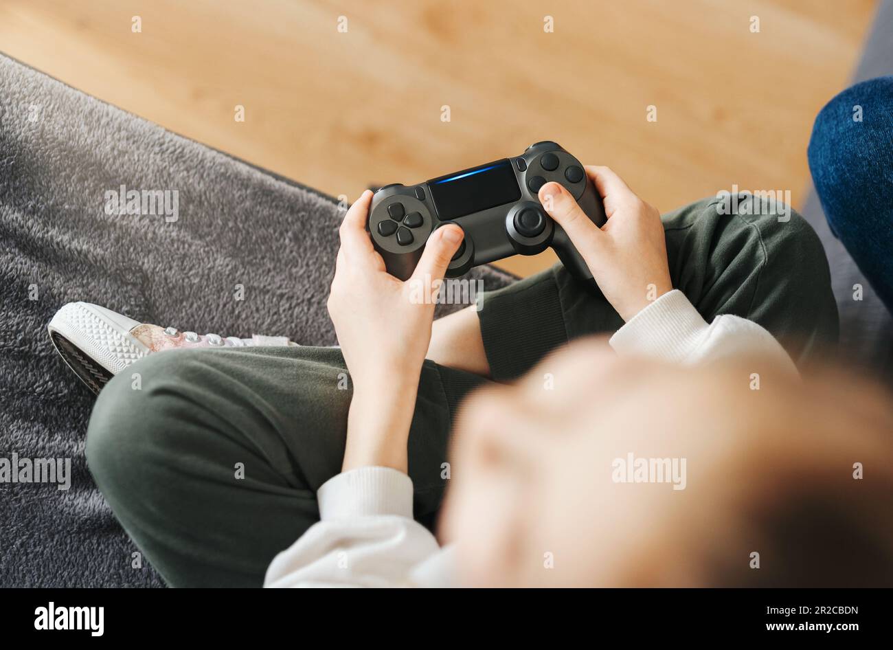 A little girl holding game controller playing video games Stock Photo ...