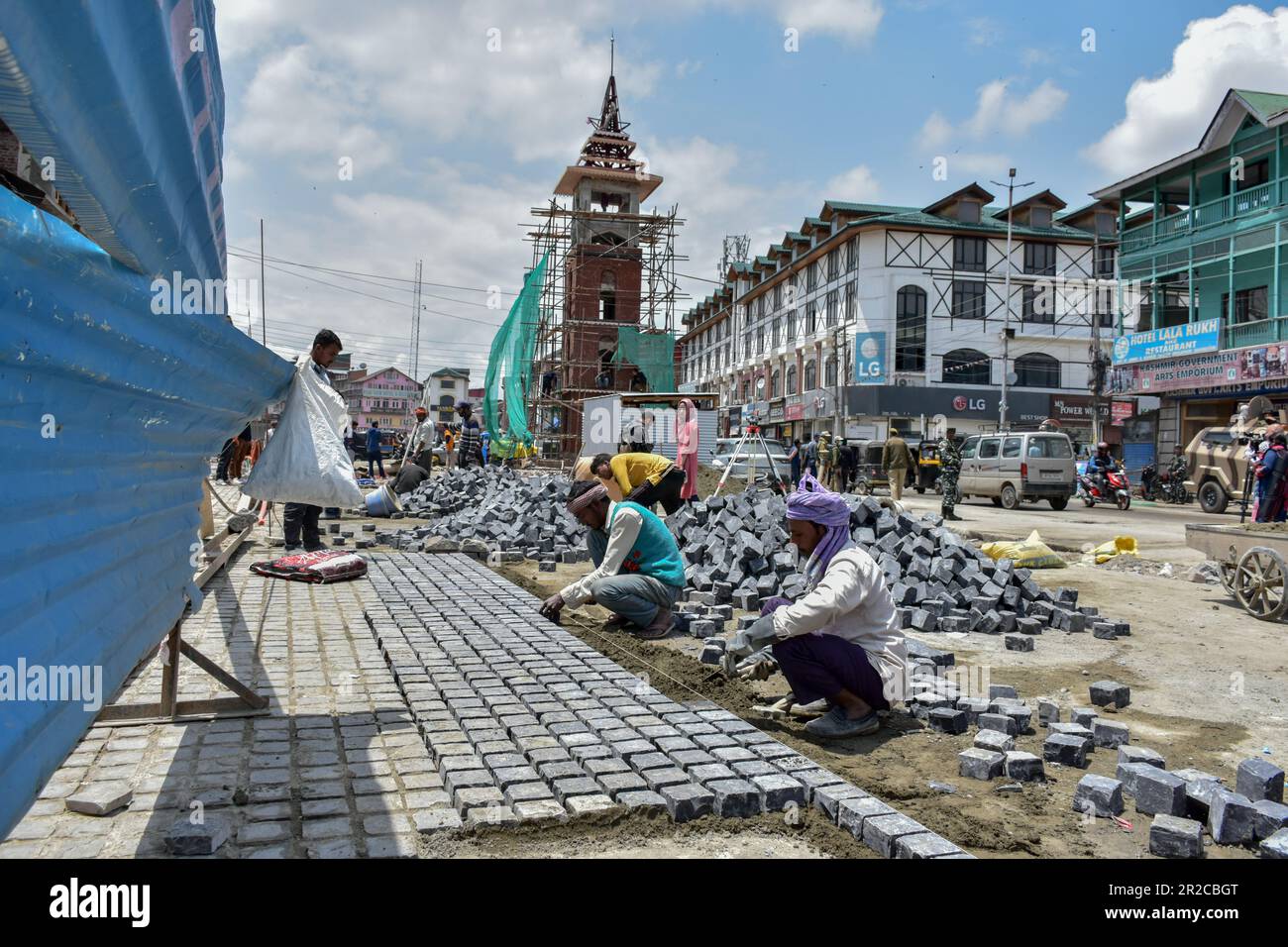 Srinagar, India. 18th May, 2023. Laborers work at the construction site ...