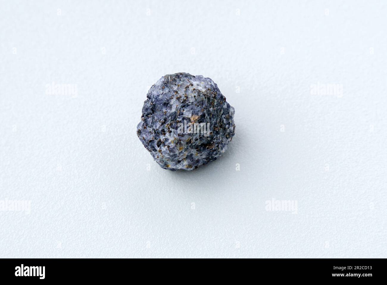 Crystal of cordierite iolite gem stone, raw mineral, white background ...