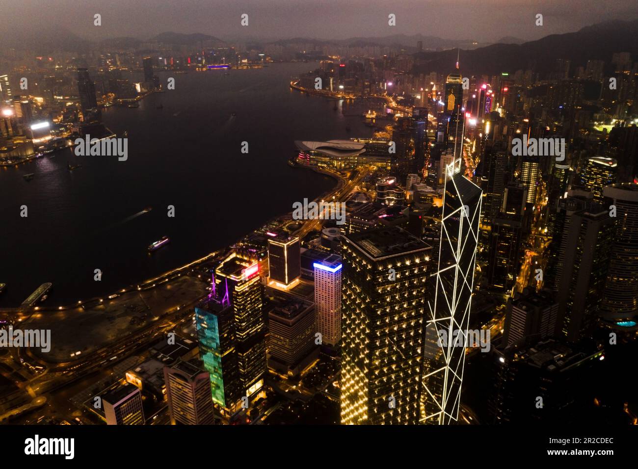 Aerial, skyscrapers and night city of office buildings with lake ...